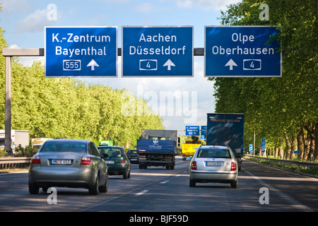 Cars driving on a German autobahn motorway with road signs near Koln in ...