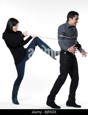 woman binding his man with a chain on white background Stock Photo - Alamy