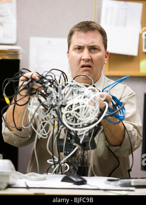 mature man trying to figure out a car breakdown leaning over the engine ...