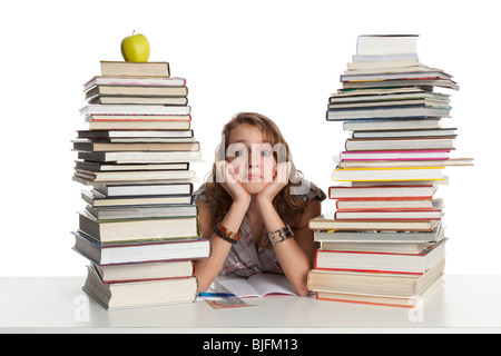 Teenage girl is making homework between a pile of heavy books Stock ...