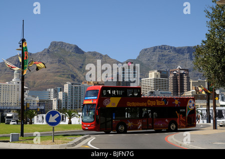 Red bus of City Sightseeing Cape Town and the skyline of Cape Town ...