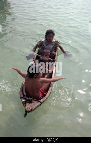 Sea gypsies, Moken woman and child looking out of a hut, Mergui ...
