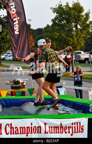 Lumberjacks compete in the log rolling competition during the Great ...