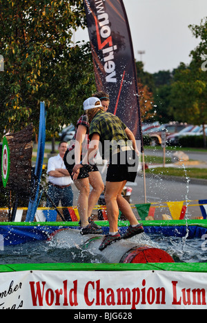 Lumberjacks compete in the log rolling competition during the Great ...