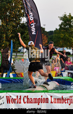 Lumberjacks compete in the log rolling competition during the Great ...