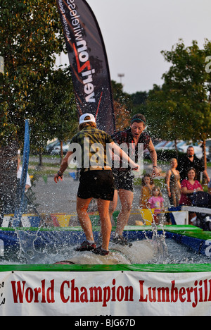 Lumberjacks compete in the log rolling competition during the Great ...