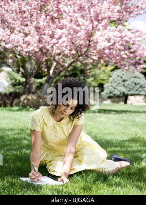 Woman in yellow dress sitting in front of chess and planning strategy ...