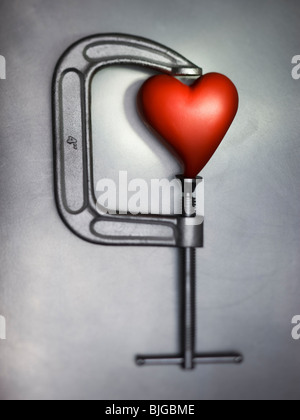 heart in a clamp Stock Photo - Alamy