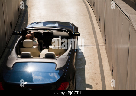 Car driving out of underground parking garage rear elevated view ...