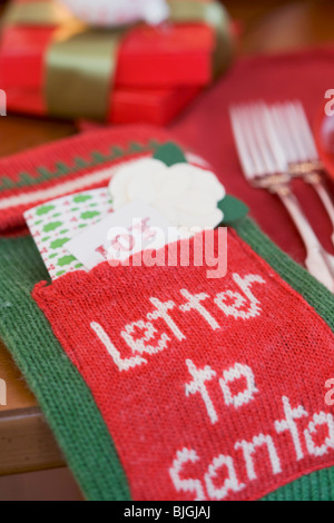 red Christmas stocking on a blurry festive background Stock Photo - Alamy