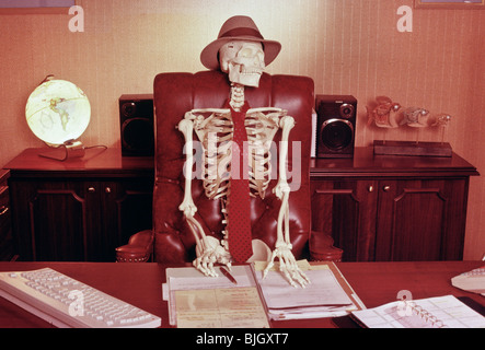 Businessman working with skeleton in office Stock Photo - Alamy