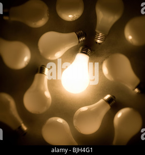 One light bulb lit up amongst others turned off Stock Photo - Alamy