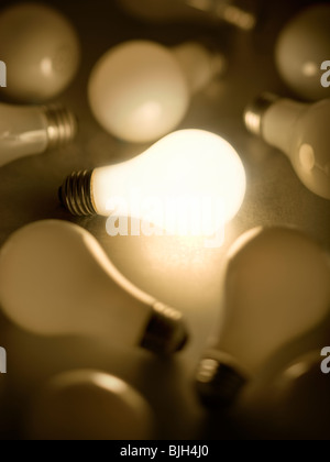 Many light bulbs on color background hanging from above Stock Photo - Alamy