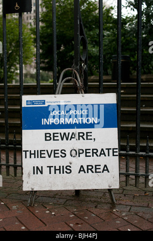 A police warning sign that thieves operate in this area Stock Photo - Alamy