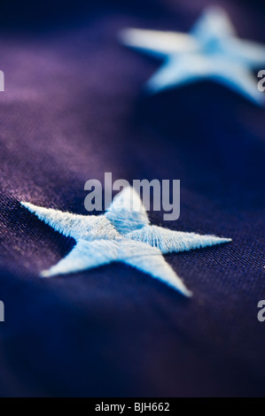 Vertical shot of the flag of the United States hung on a metal stand in ...