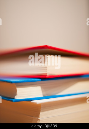 Vertical stack of three red books isolated over white background ...