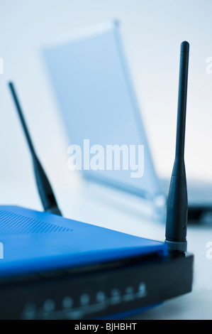 closeup of a wireless router and Laptop computers on living room at ...