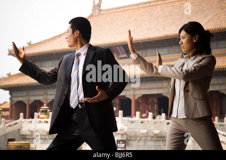 Businesswoman and man doing tai chi outdoors Stock Photo - Alamy