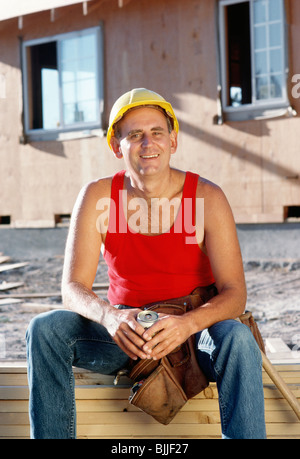 Blue-collar worker looking at construction site Stock Photo - Alamy