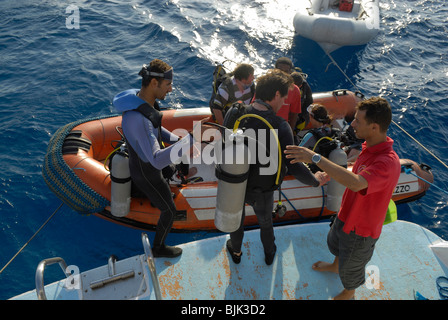 Scuba divers in inflatable going to dive site. Galapagos Islands, model ...