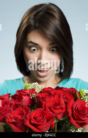 Women surprised with bouquet of red roses Stock Photo - Alamy