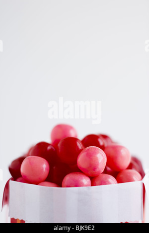 A vertical shot of a box of white beans with a red plastic scoop for ...