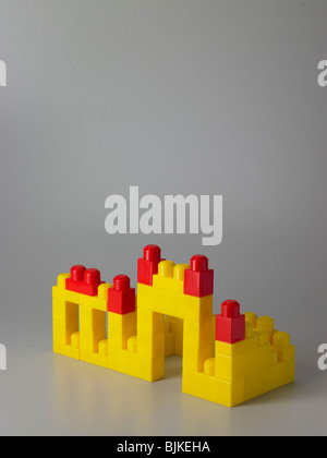 Yellow toy blocks showing building and structure. face on Stock Photo ...