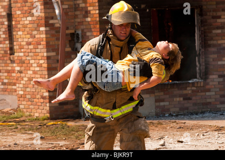 Fire fighter rescuing child Stock Photo - Alamy
