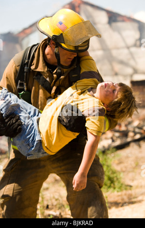 Fire fighter rescuing child Stock Photo - Alamy
