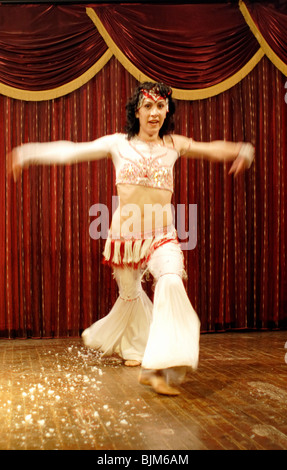 Turkish woman dancing dressed in traditional dress with wooden spoons ...