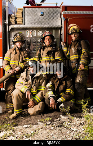 Group portrait of firefighters and fire engine Stock Photo - Alamy