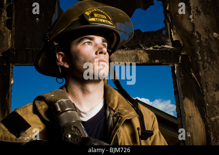 Portrait of a firefighter with fire hose Stock Photo - Alamy
