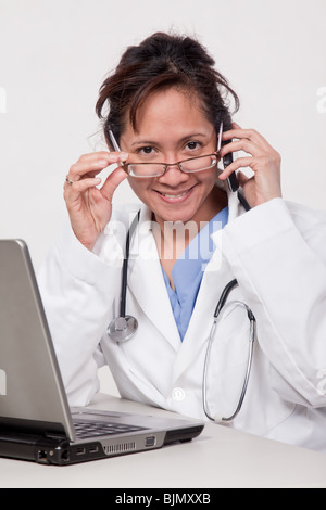 Asian professional doctor woman working online at home office using ...