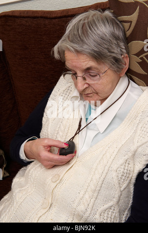 Elderly lady with emergency alarm around neck Stock Photo - Alamy