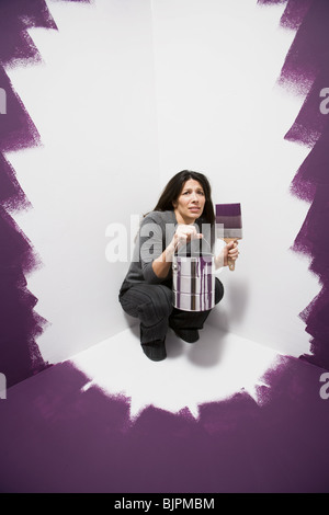Scared woman sitting in the corner Stock Photo - Alamy