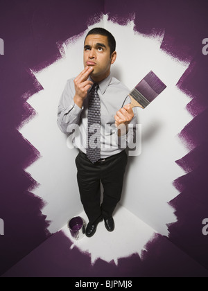 thoughtful man standing in the corner Stock Photo - Alamy