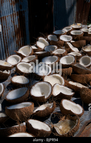 coconuts that have been split, dried in the sun and then separated from ...