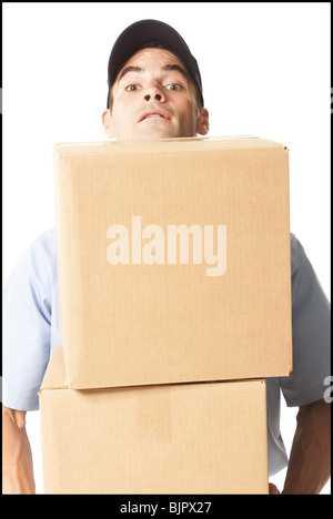 Portrait of surprised shocked delivery man in uniform pointing finger ...