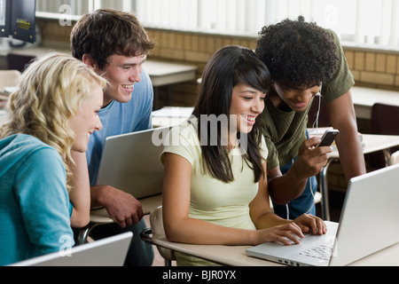 people crowded around a computer Stock Photo - Alamy
