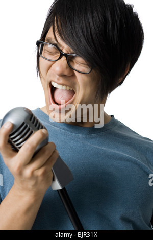 Man rocking out with mic stand Stock Photo - Alamy