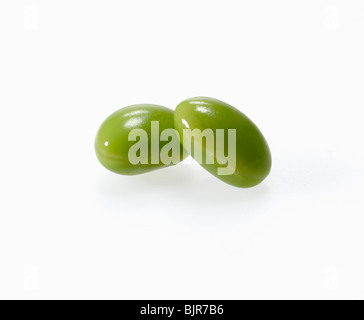 Fresh edamame soybeans in white dish. Rustic wood surface with garlic ...