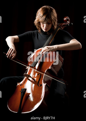 A young woman and the cello Stock Photo - Alamy