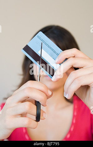 Woman cutting credit card in half Stock Photo - Alamy