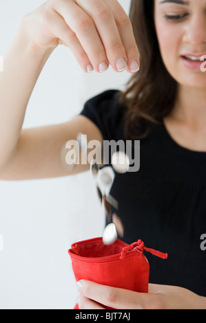 Woman Dropping Coins Stock Photo - Alamy