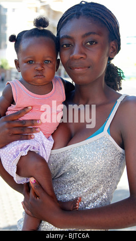 A mother holds her child, Angolan street life. Benguela, Angola. Africa ...