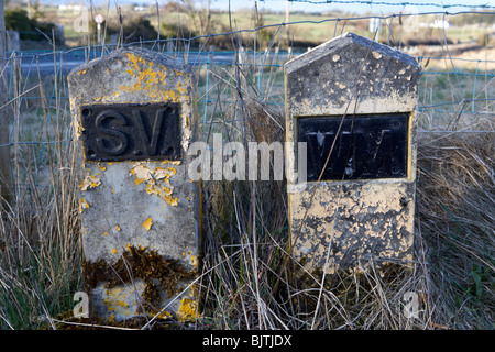 Concrete water main marker post showing pipe diameter size and distance ...