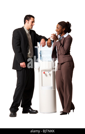 Office workers talking by water cooler in hallway Stock Photo - Alamy