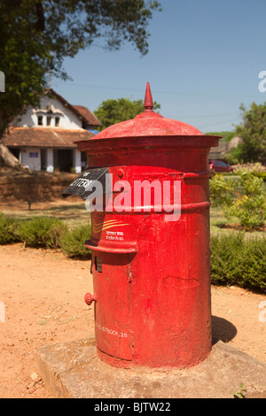 A postbox in Mysore, India. The red post box bears the symbol of India ...
