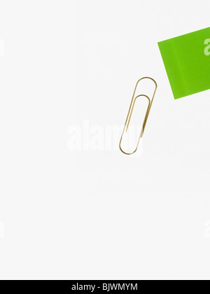 White and green note papers with paperclip on white background Stock ...