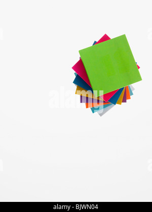 Colorful blank sticky note papers with flower on grey colour background ...
